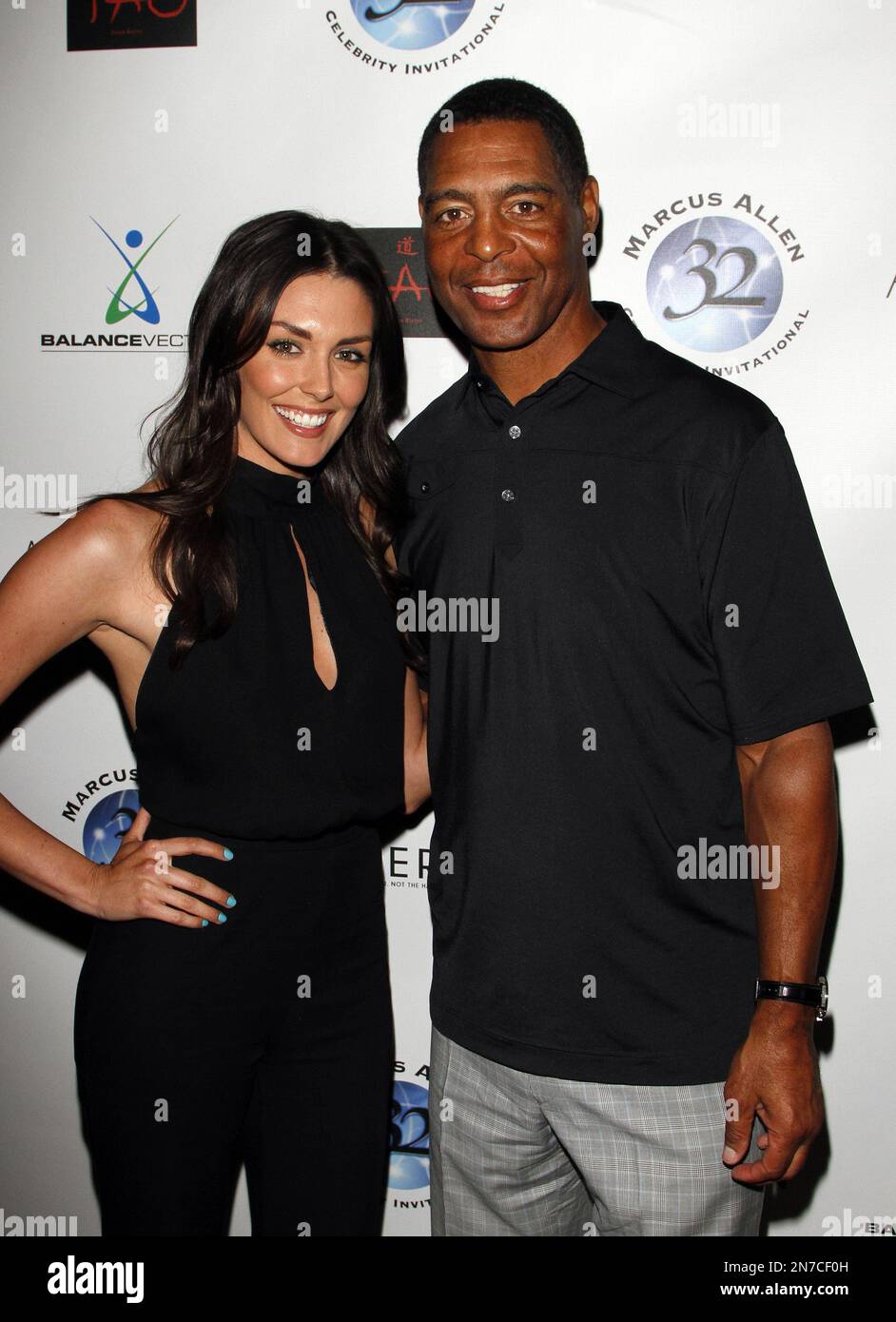 Actress Taylor Cole and Marcus Allen pose at Marcus Allen Foundation ...