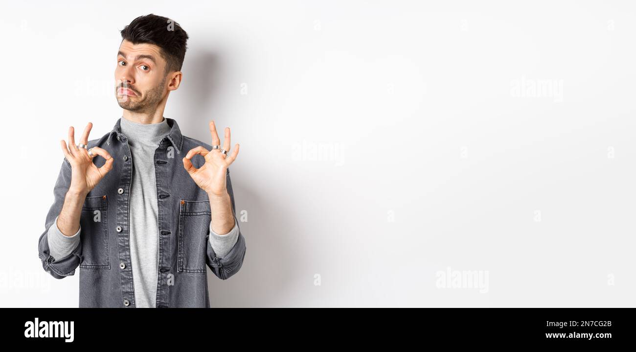 Not bad. Impressed handsome guy nod in approval, showing okay signs to ...