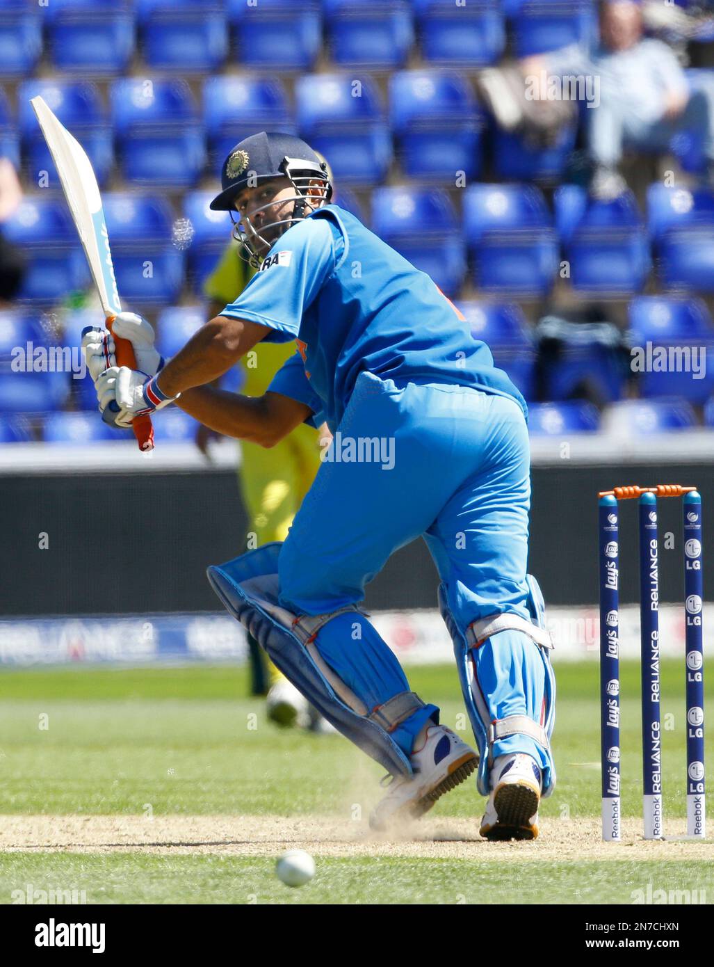 India's captain MS Dhoni plays a shot off the bowling of Australia's ...