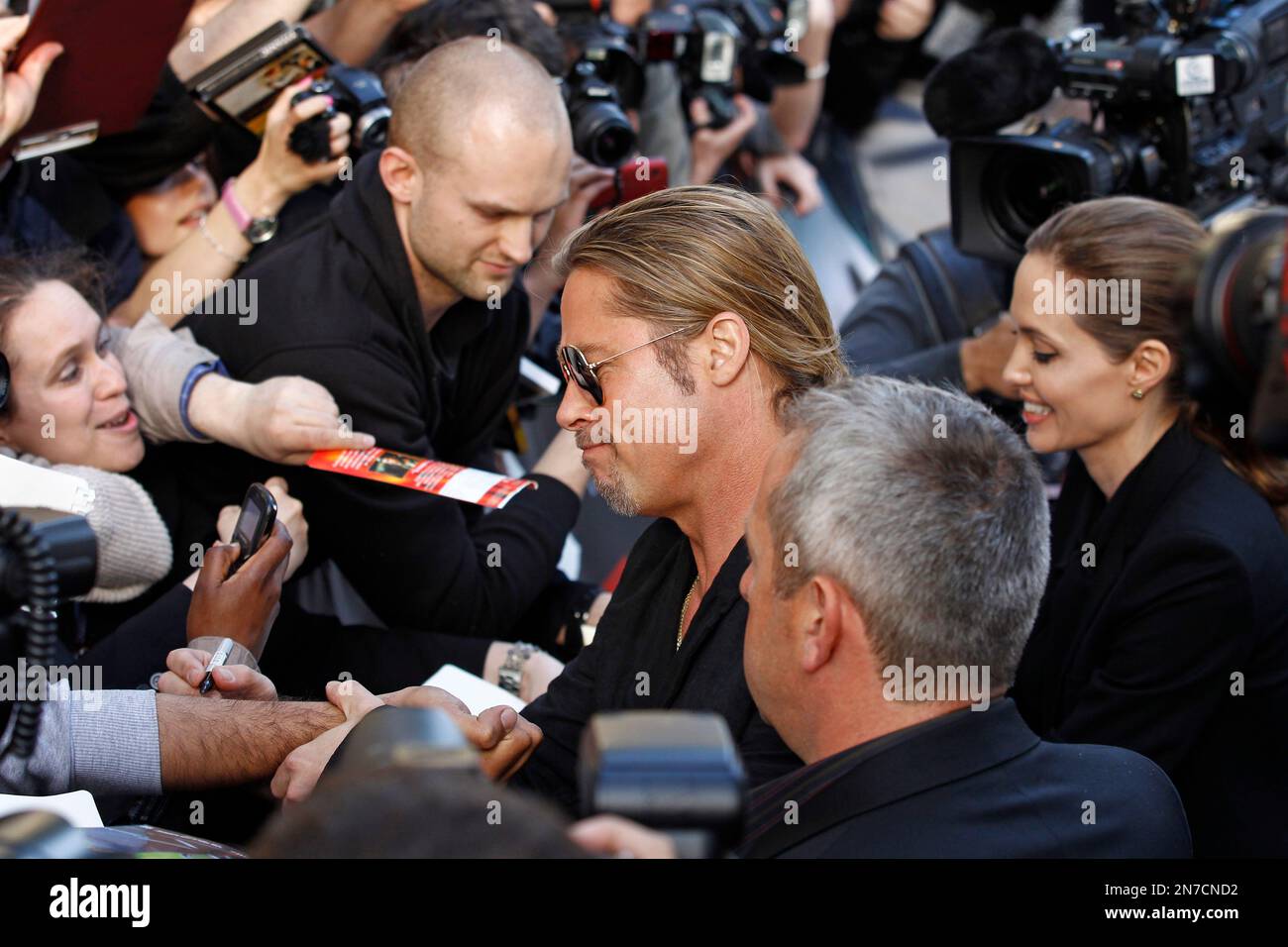 U.S. movie stars Brad Pitt and Angelina Jolie sign autographs at their ...
