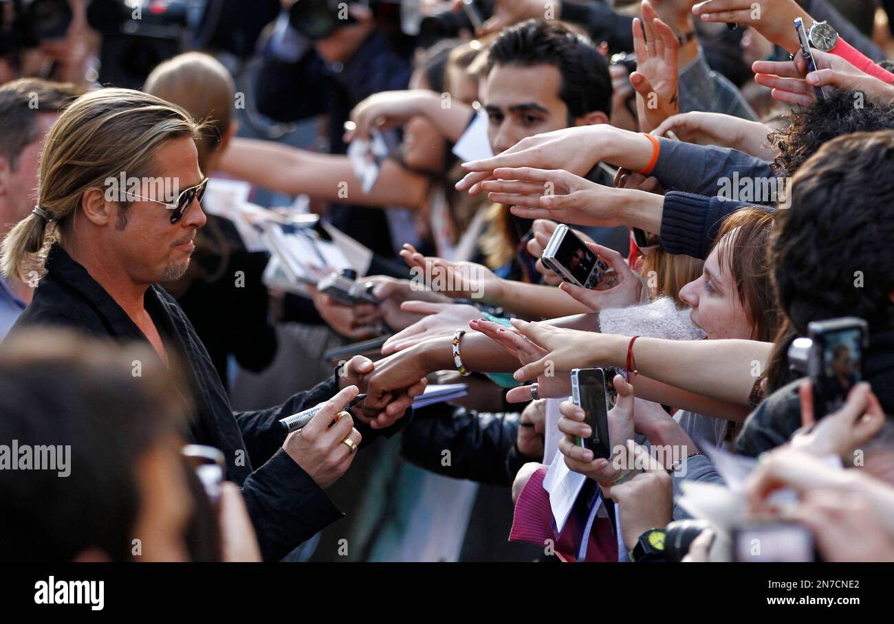 U.S. movie star Brad Pitt signs autographs at his arrival for the ...