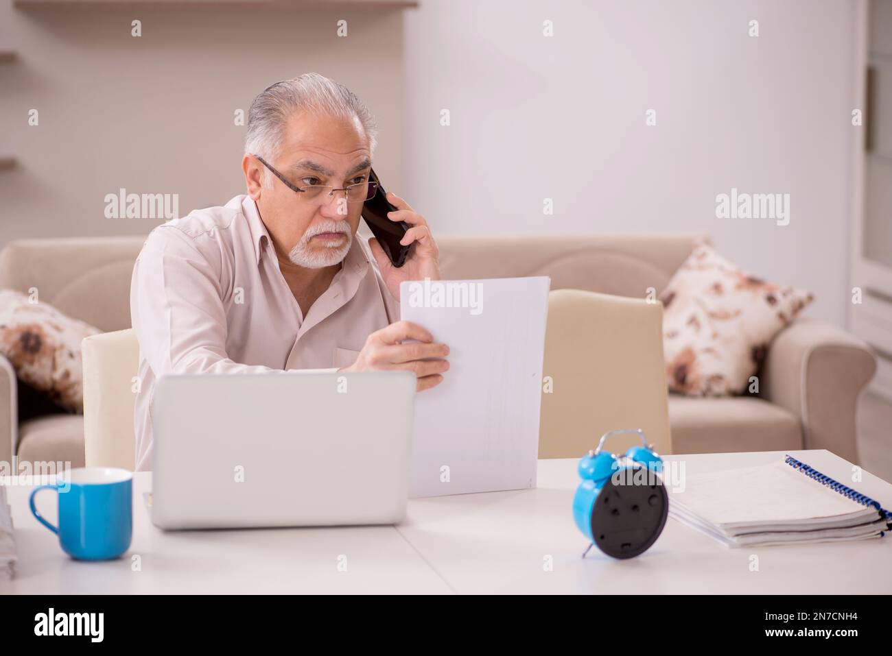 Old boss employee working from home during pandemic Stock Photo - Alamy