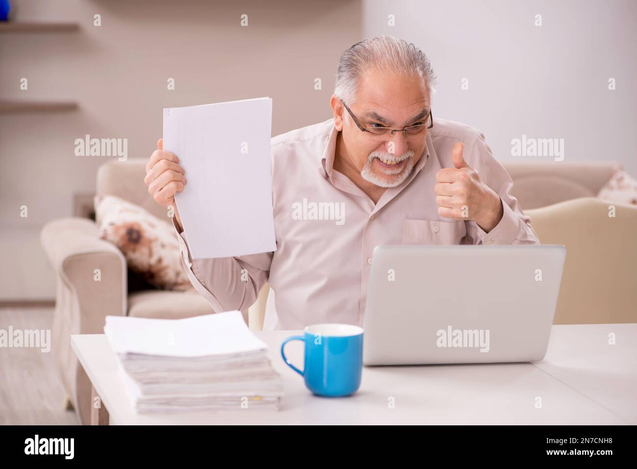 Old boss employee working from home during pandemic Stock Photo - Alamy