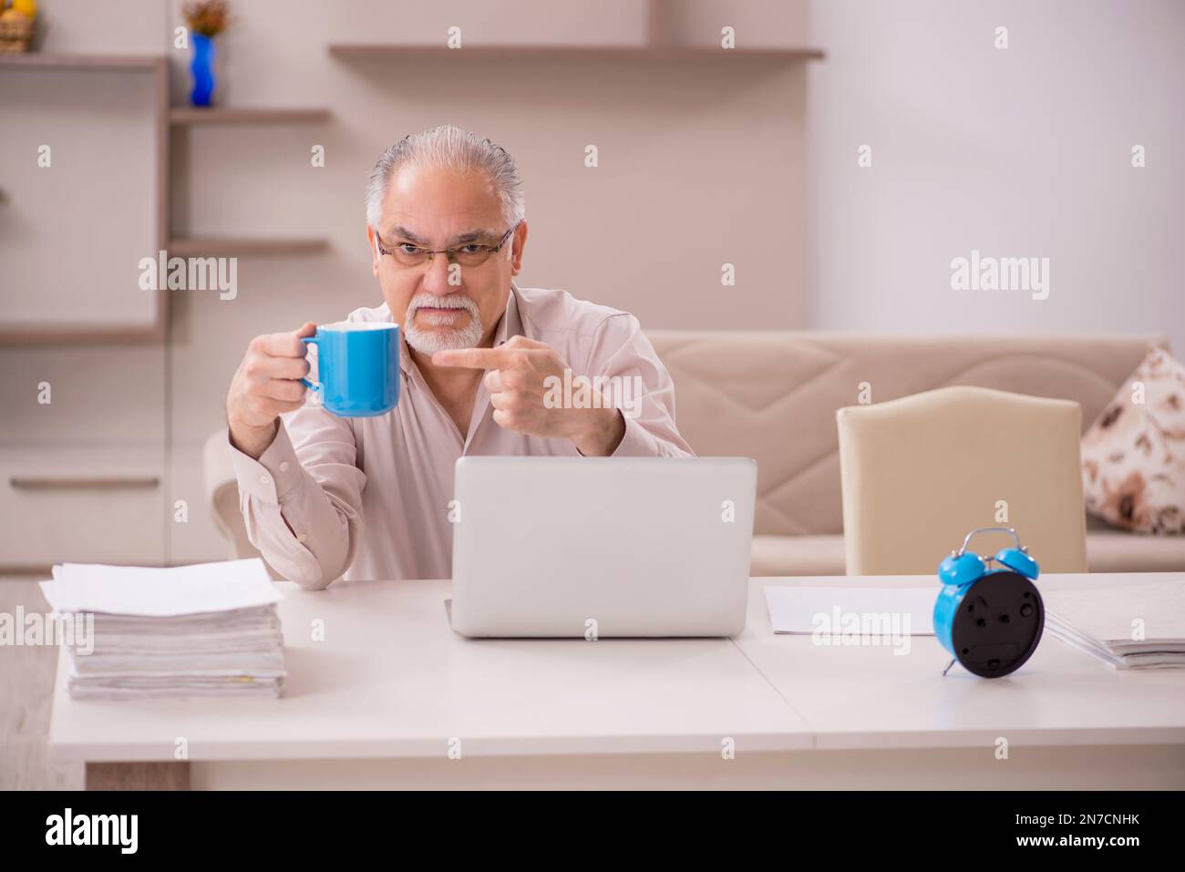 Old boss employee working from home during pandemic Stock Photo - Alamy