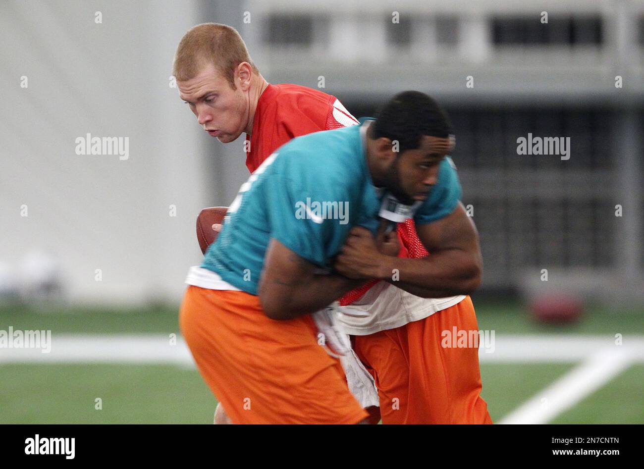 Miami Dolphins quarterback Ryan Tannehill fakes a hand off to Marcus ...