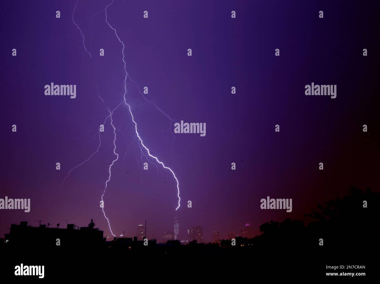 Lightning strikes over One World Trade Center, center right, during a ...