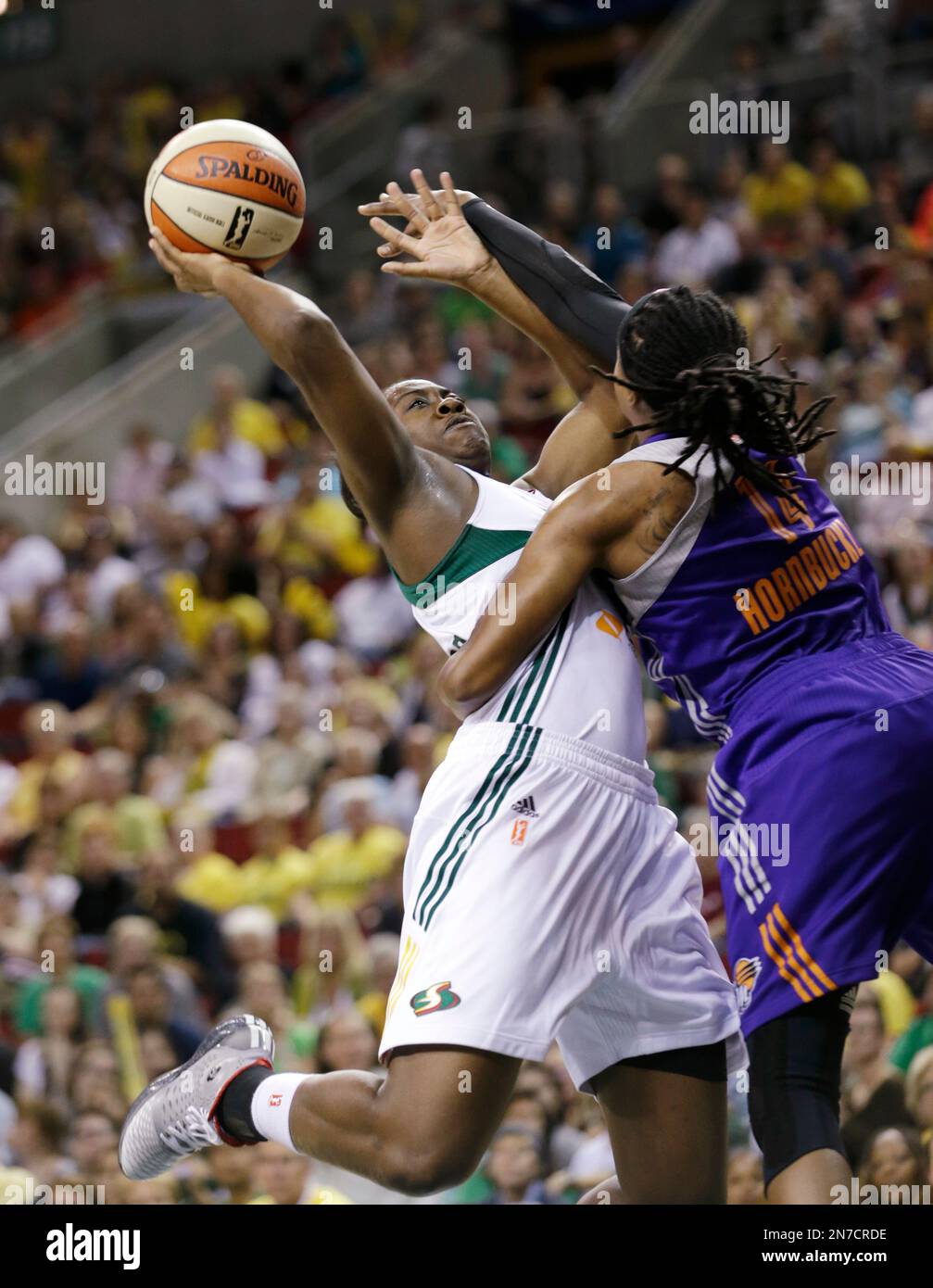 Seattle Storm's Shekinna Stricklen, left, is wrapped up in a foul by ...