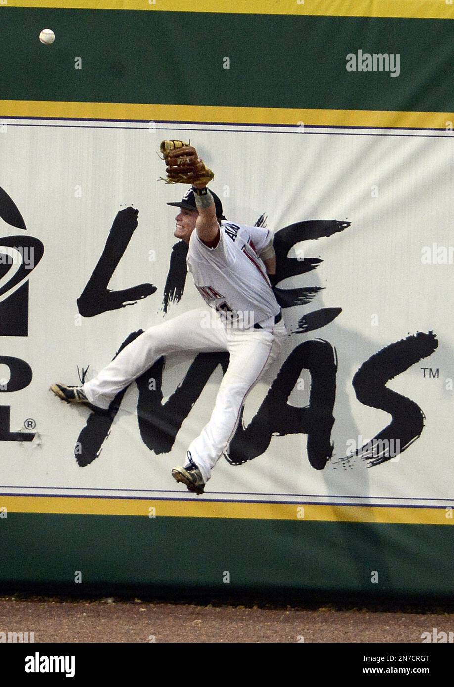 Louisiana-Lafayette left fielder Caleb Adams (13) goes high but can't ...