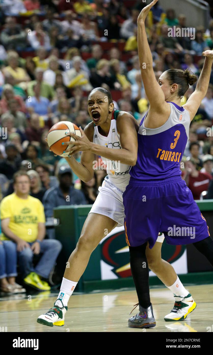 Seattle Storm's Tina Thompson, left, tries to drive past Phoenix ...