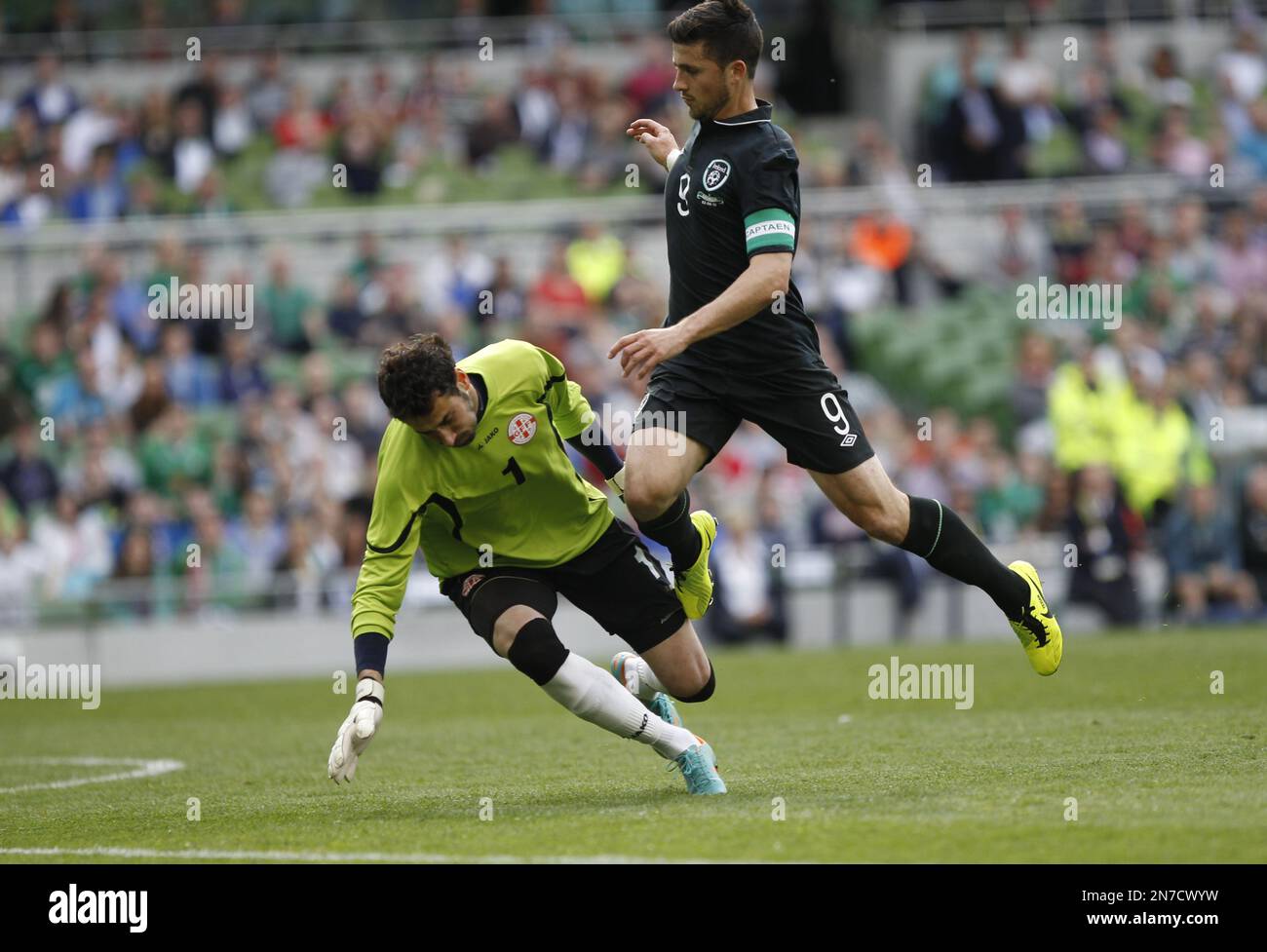 Georgia's Giorgi Loria, left, fouls Republic of Ireland's Shane Long ...