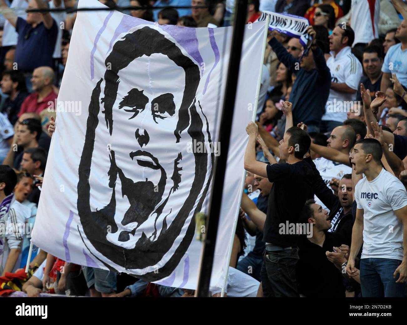 Real Madrid's fans hold a banner with the face of Jose Mourinho on it ...