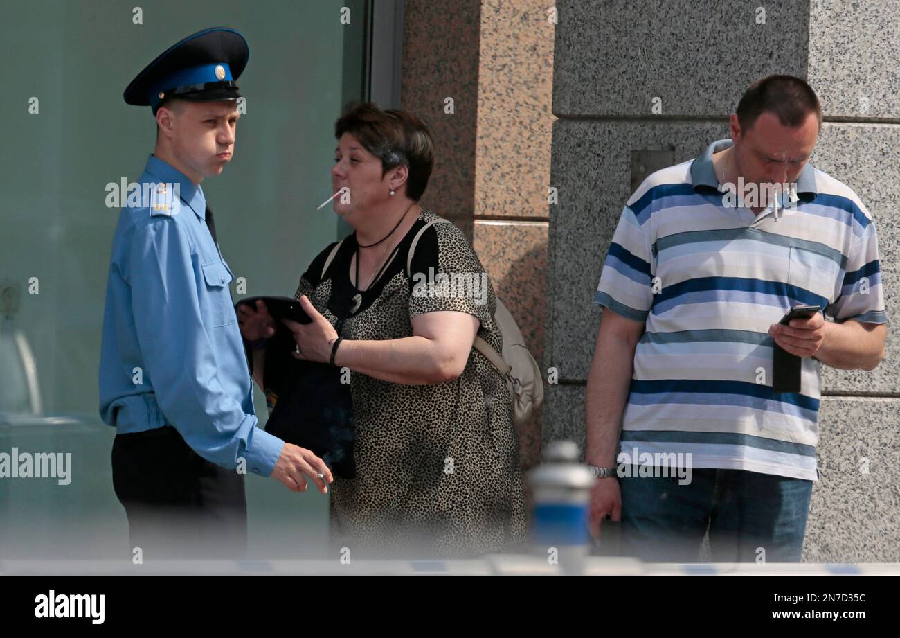 People smokes outside a shopping mall in downtown Moscow, Russia ...