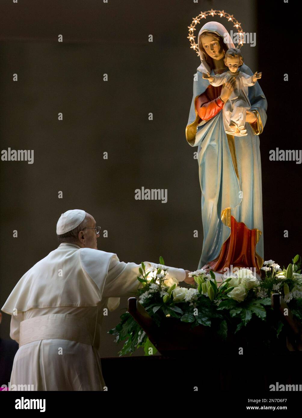Pope Francis pays homage to a statue of the Virgin Mary during a ...