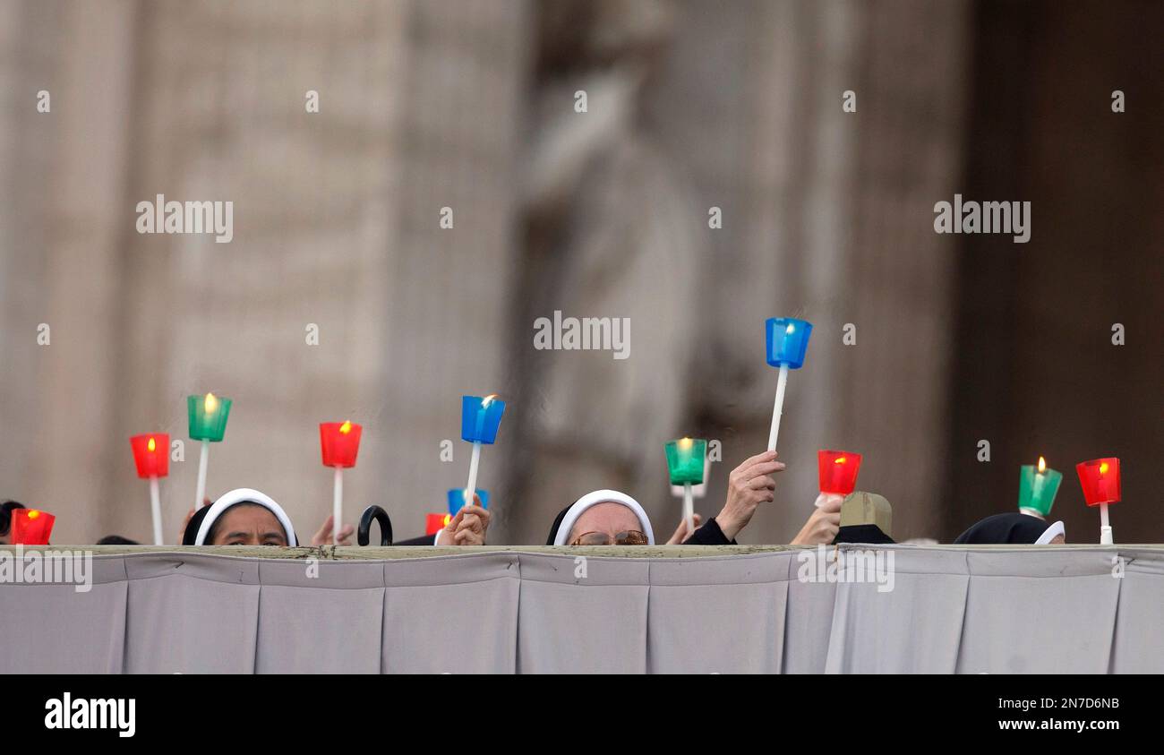 Nuns hold up candles during a rosary led by Pope Francis,not pictured ...