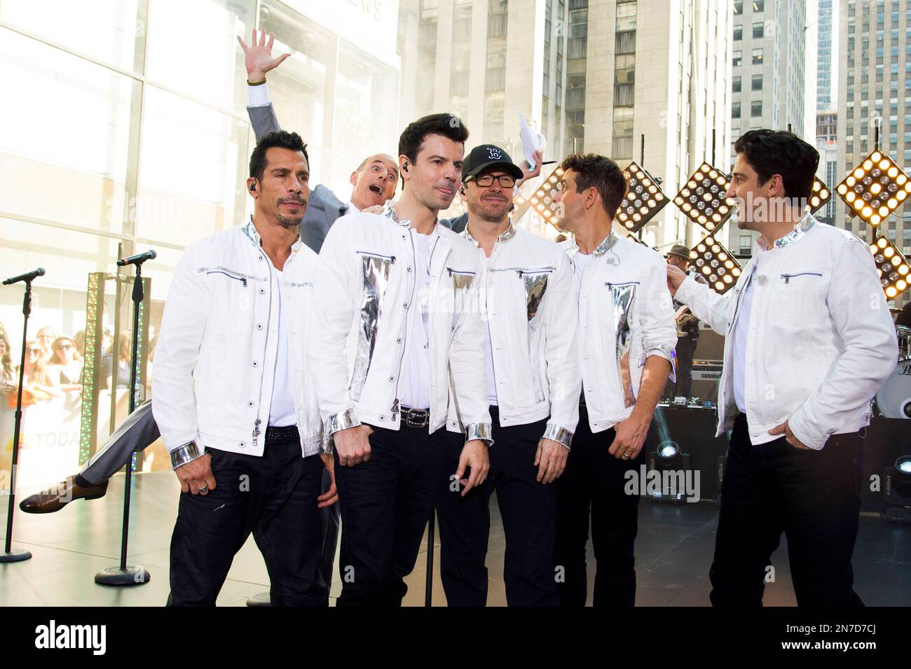 Matt Lauer, background, jumps behind New Kids on the Block band members ...