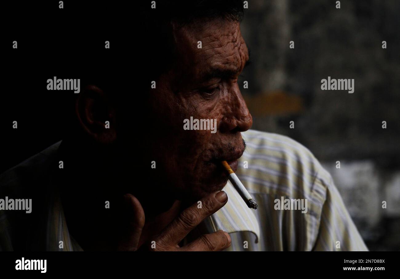 An Indonesian man smokes a cigarette in Jakarta, Indonesia,Friday, May ...