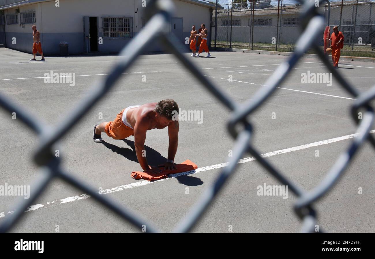 Inmate Kevin Barry does pushups in the exercise yard of Sacramento ...