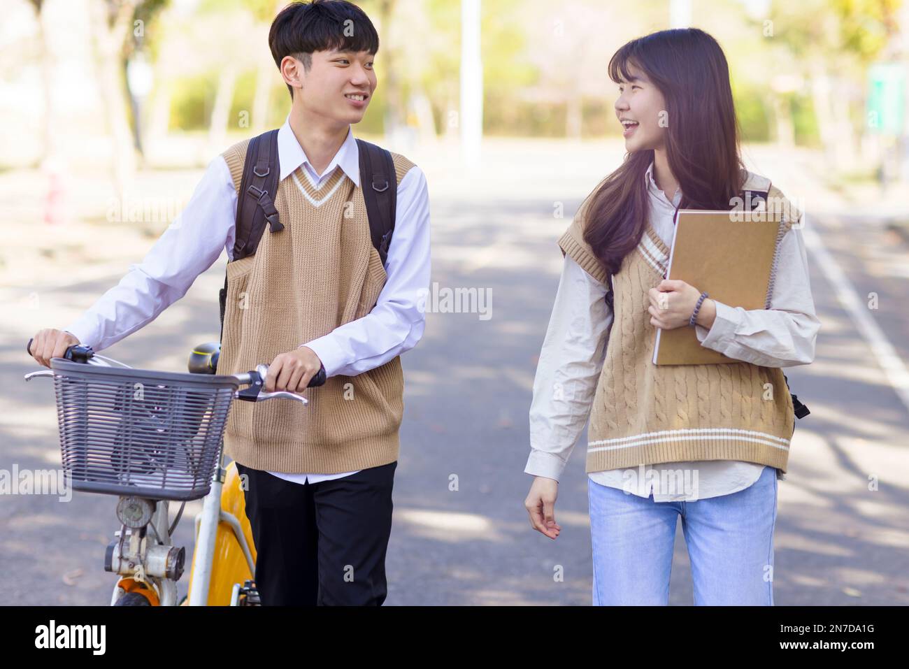 Happy students walking together in the school Stock Photo - Alamy