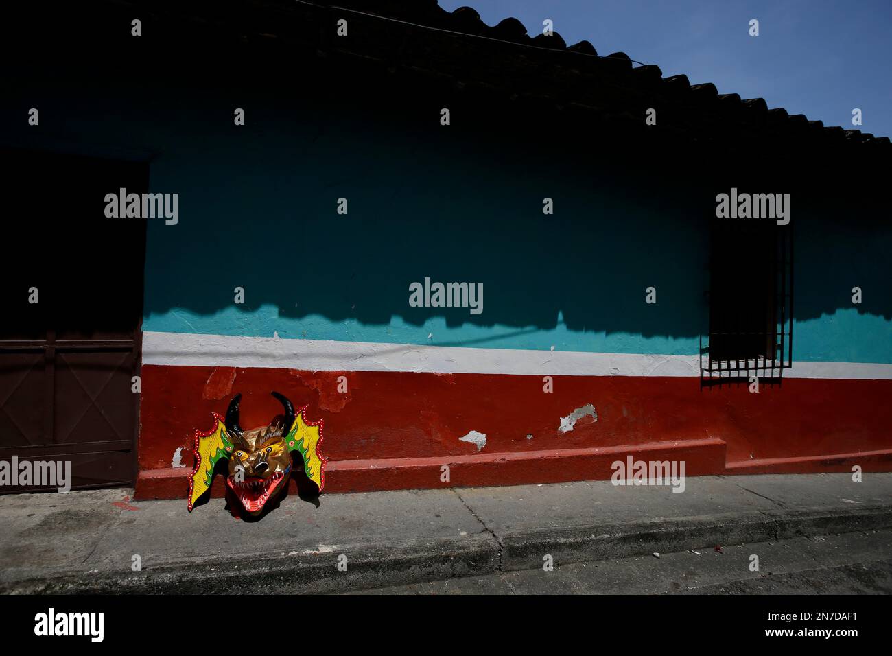 A devil mask is propped against a wall in San Francisco de Yare ...