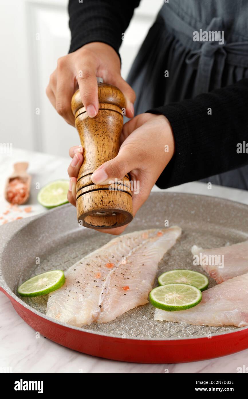 Grind Black Pepper to Boneless Fish Meat Fillet, Female Chef in Action ...