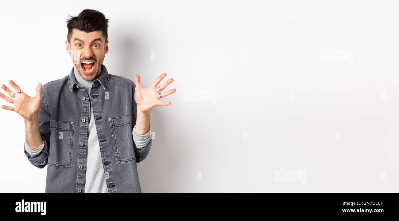 Angry man scream and look scary at camera, shouting with furious and ...