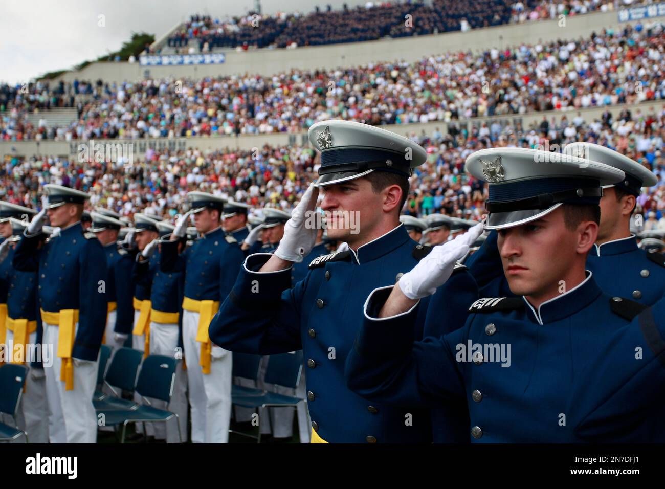 Graduating Air Force cadets salute at the start of the commencement ...