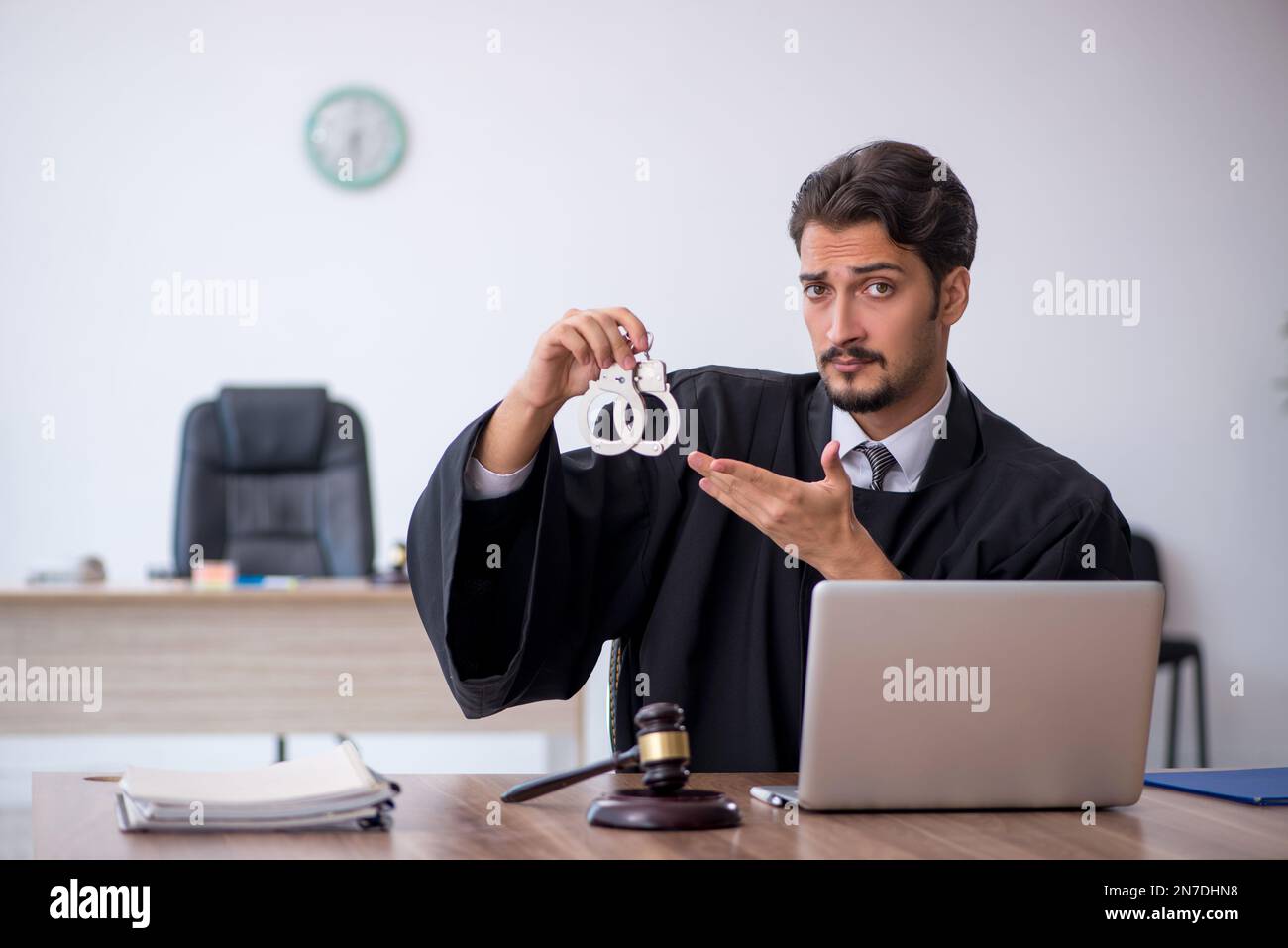 Young judge working in the courthouse Stock Photo - Alamy