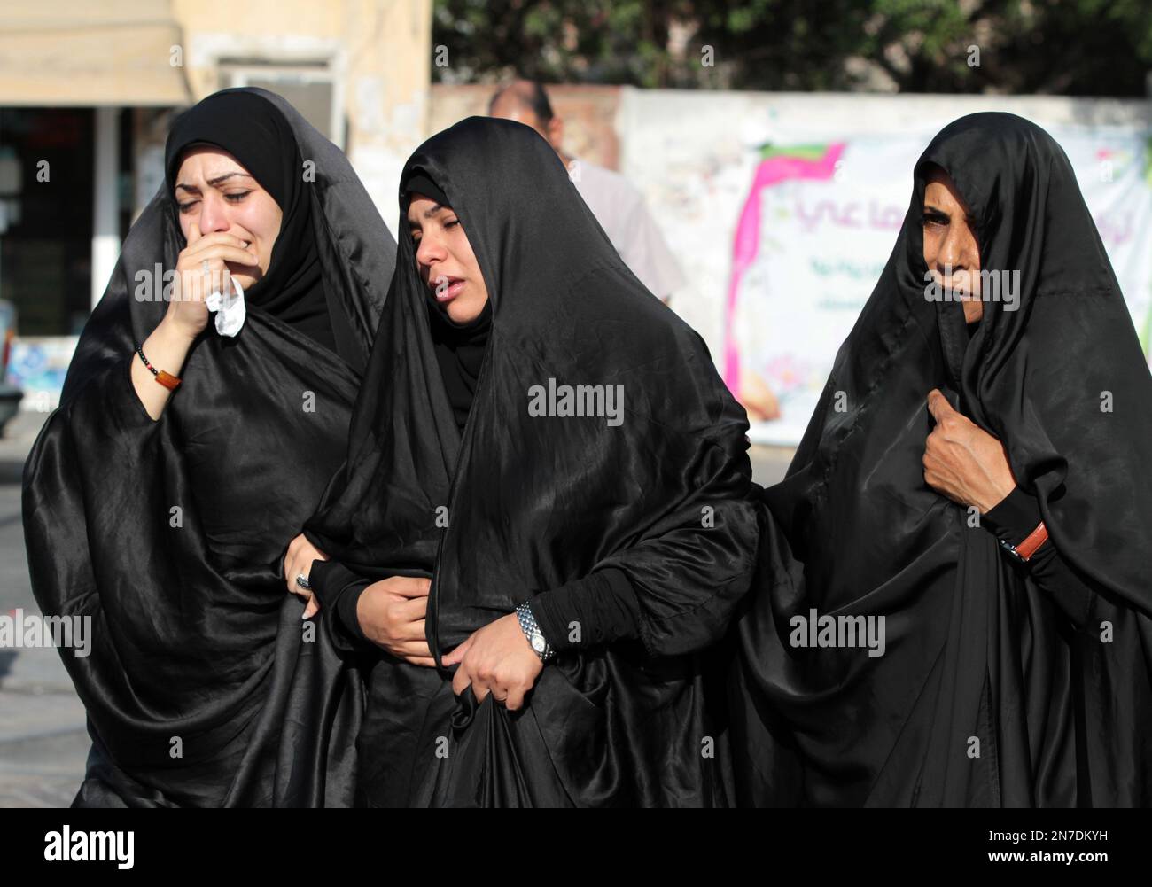 Women weep as they walk to join a politically charged funeral ...