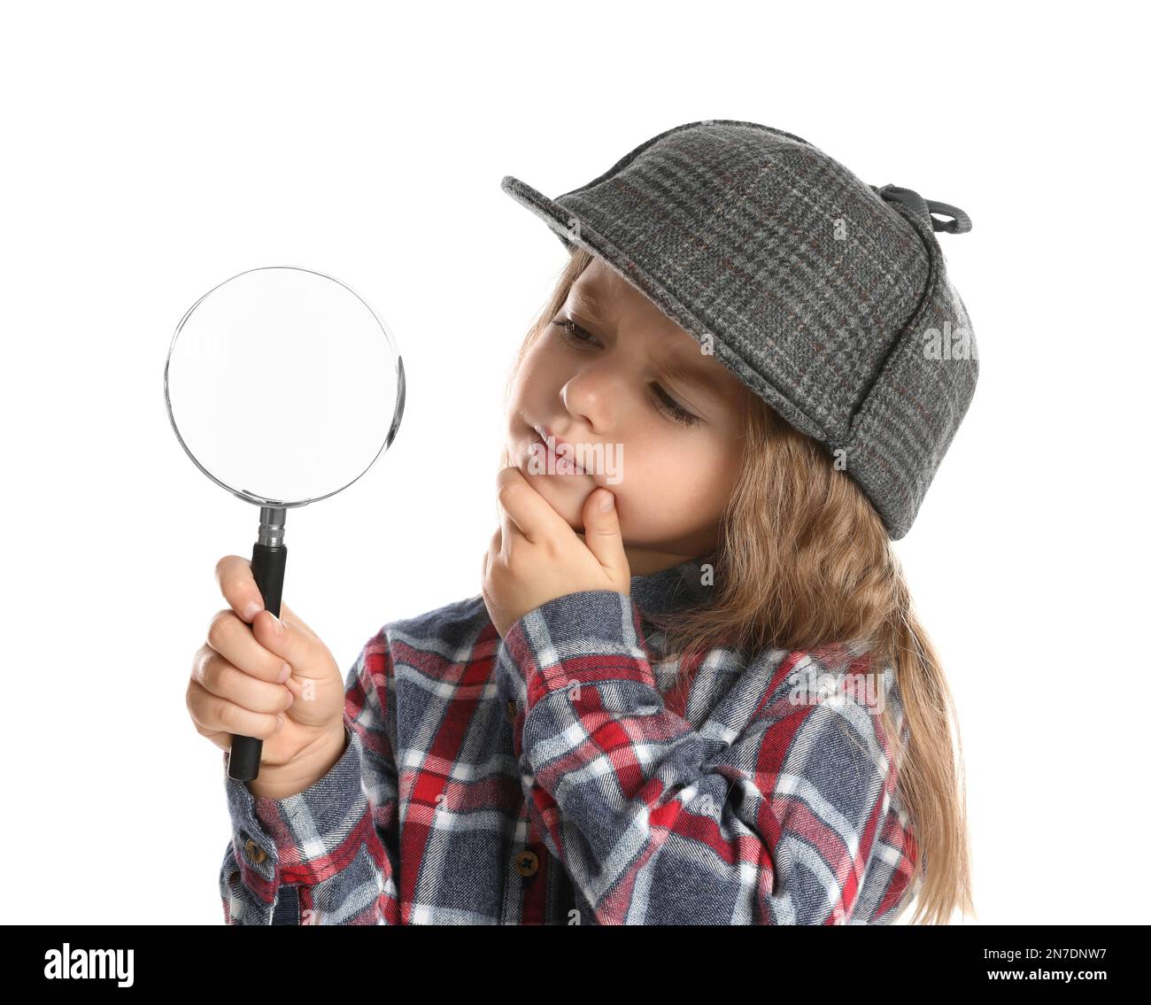 Cute little child in hat with magnifying glass playing detective on ...