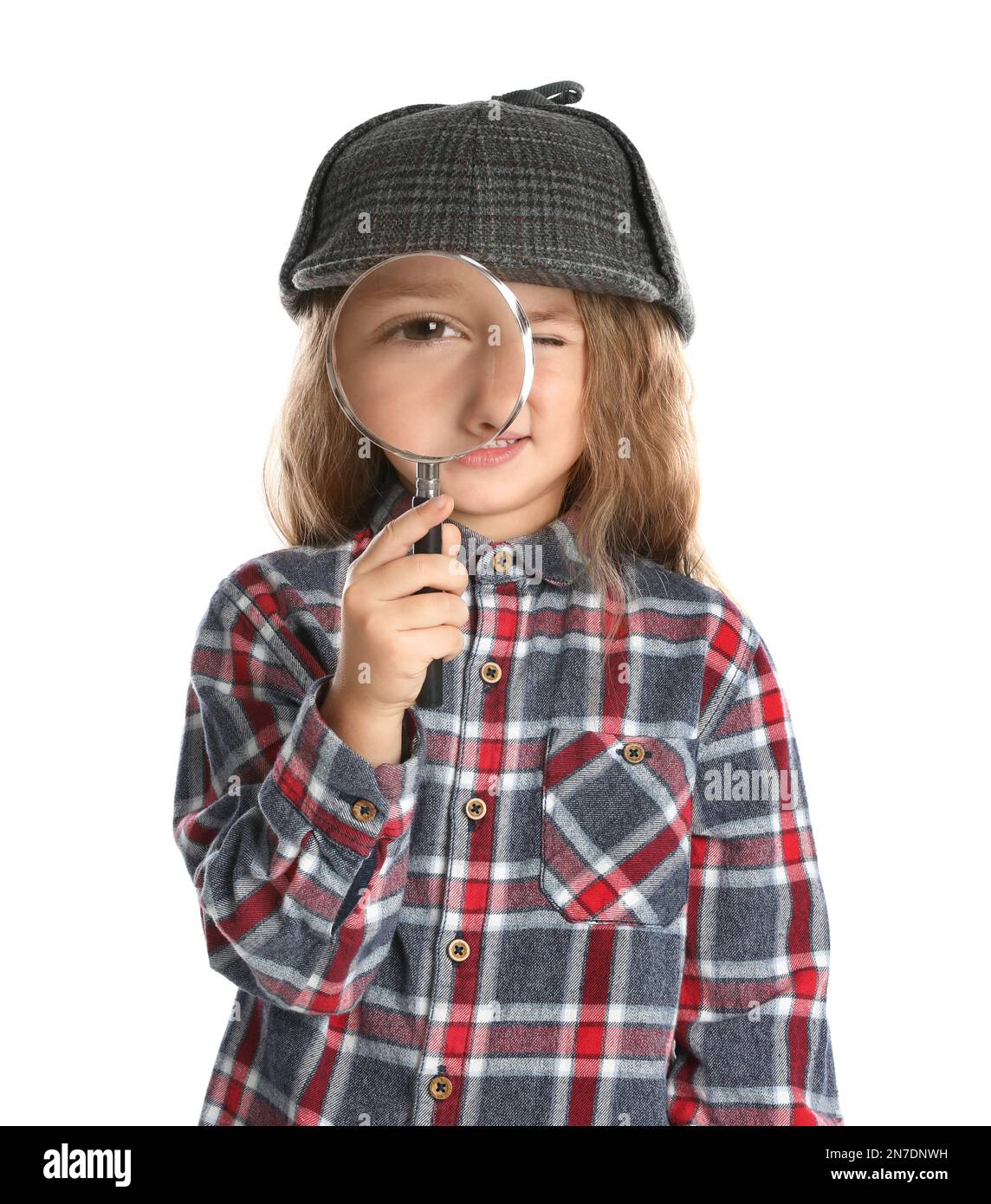 Cute little child in hat with magnifying glass playing detective on ...