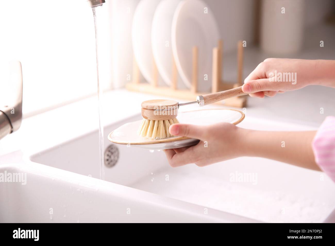 Little girl washing dishes in kitchen, closeup Stock Photo - Alamy