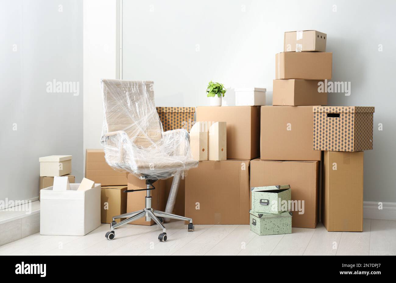 Cardboard boxes and packed chair indoors. Moving day Stock Photo - Alamy