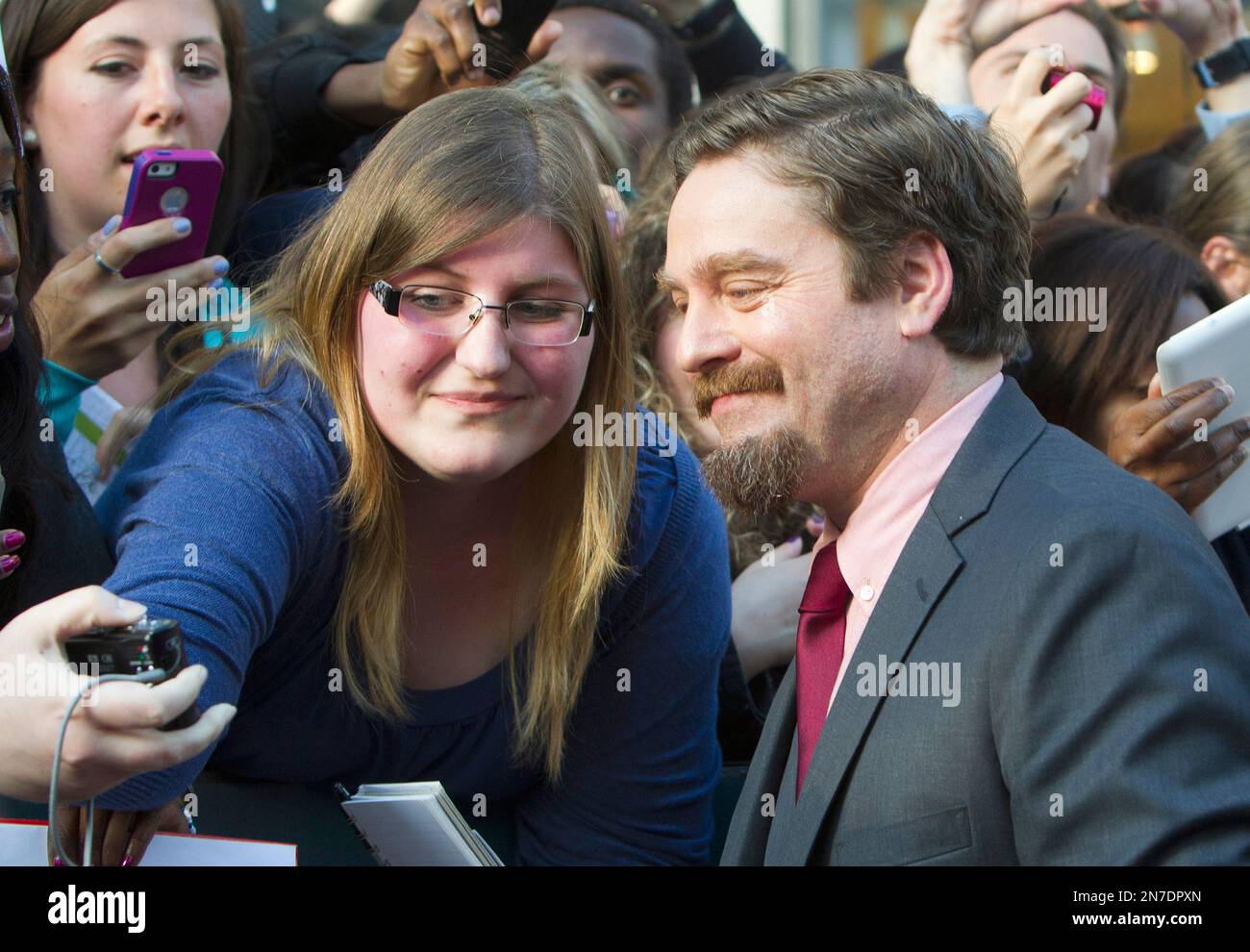Actor Zach Galifianakis poses for a photo with a fan as he arrives for ...