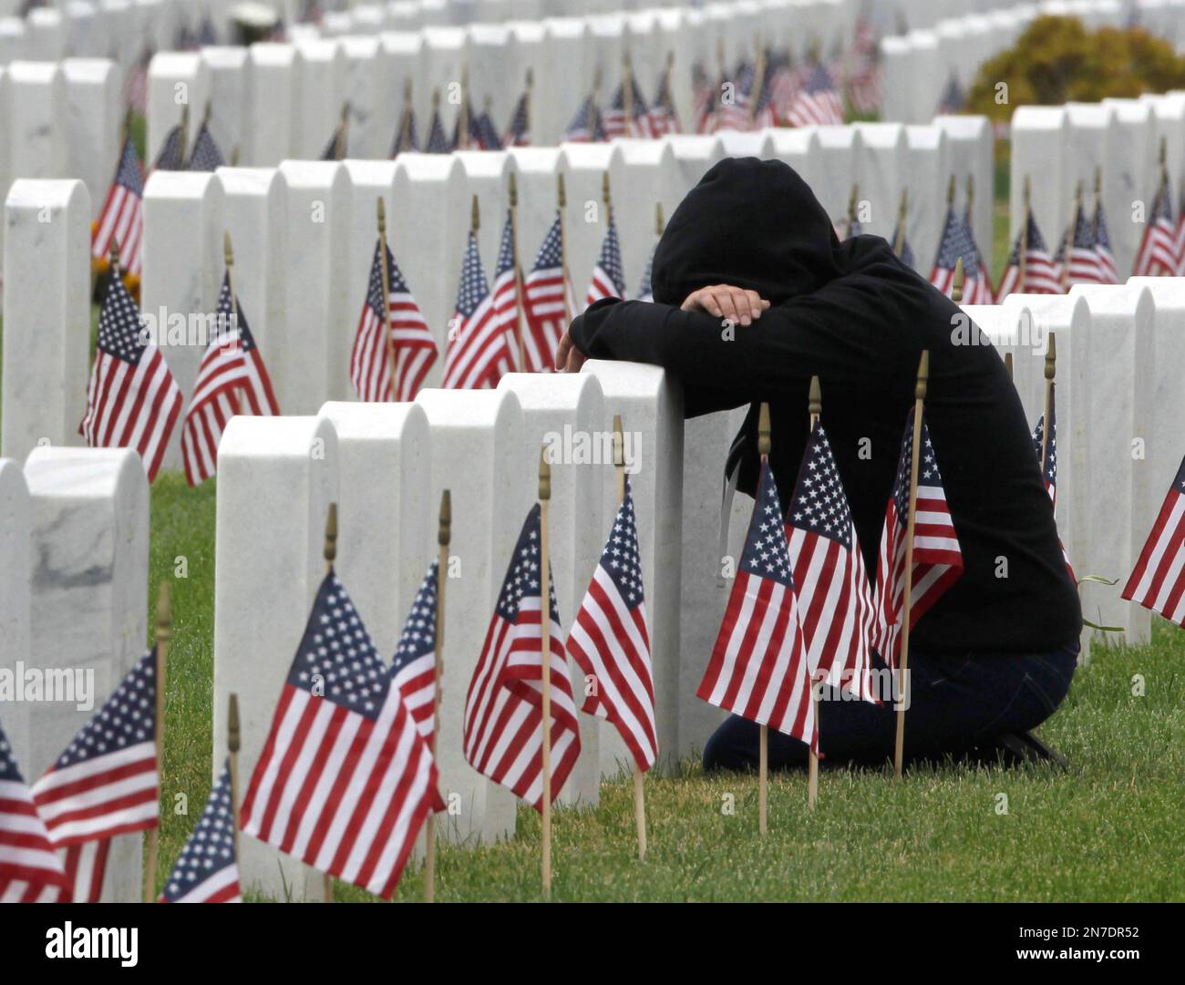 Michelle Thacker buries her head in her arms as she visits the grave of ...