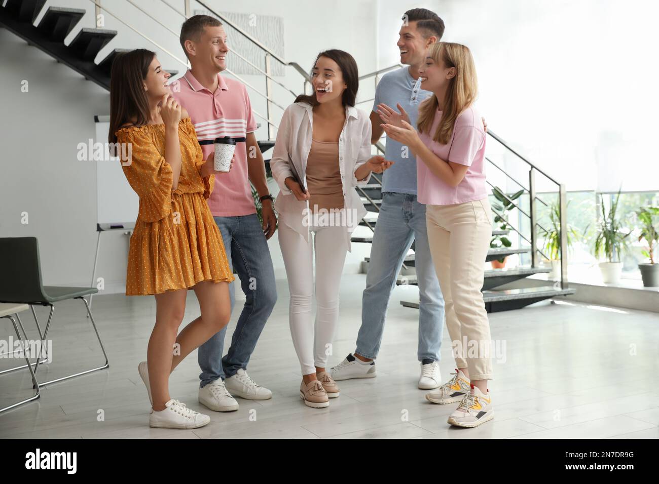 Group of people having conversation in hall Stock Photo - Alamy