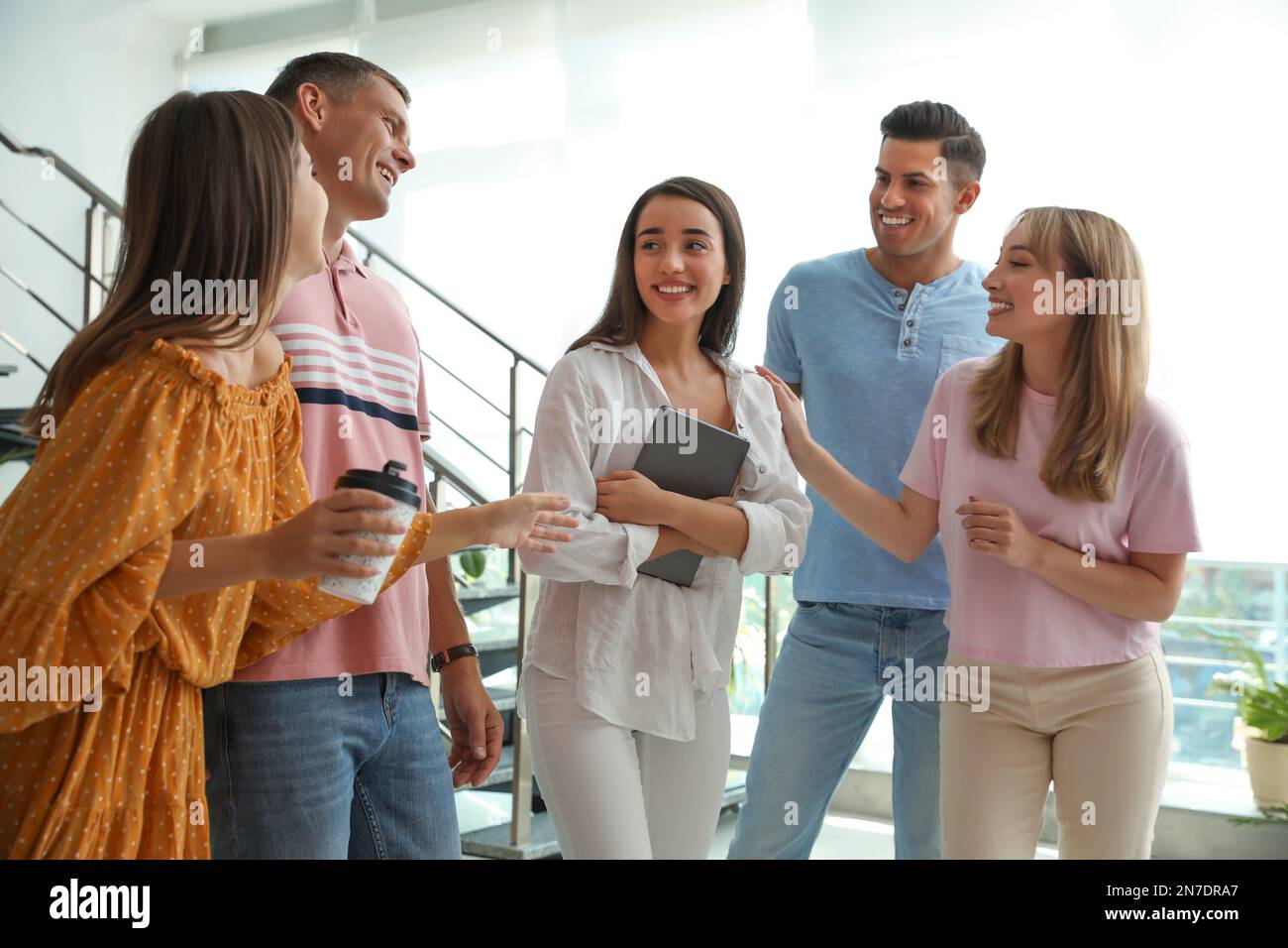 Group of people having conversation in hall Stock Photo - Alamy