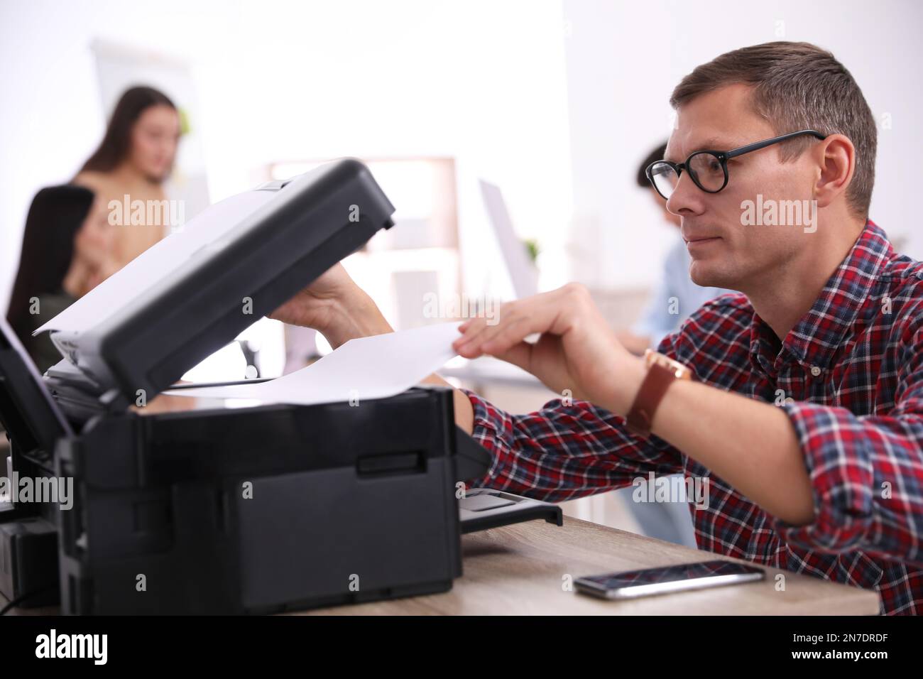Employee using new modern printer in office Stock Photo - Alamy