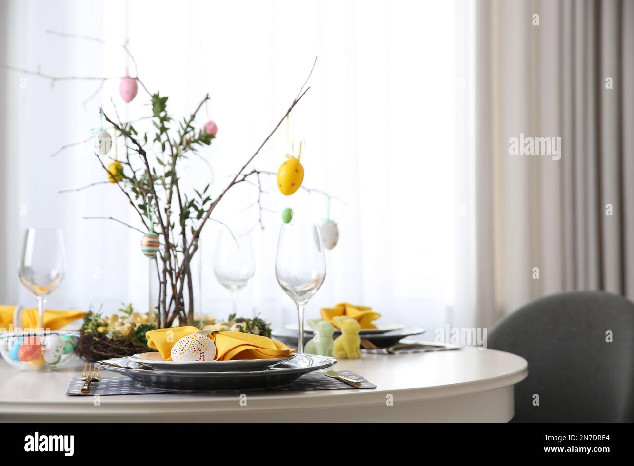 Beautiful Easter table setting with floral decor indoors Stock Photo ...