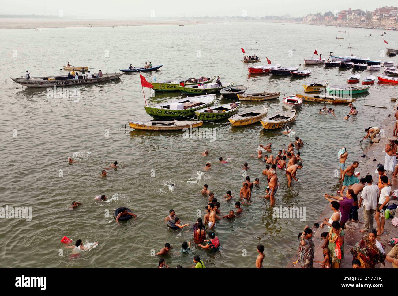 Indian people take dips in the River Ganges to beat the heat in ...