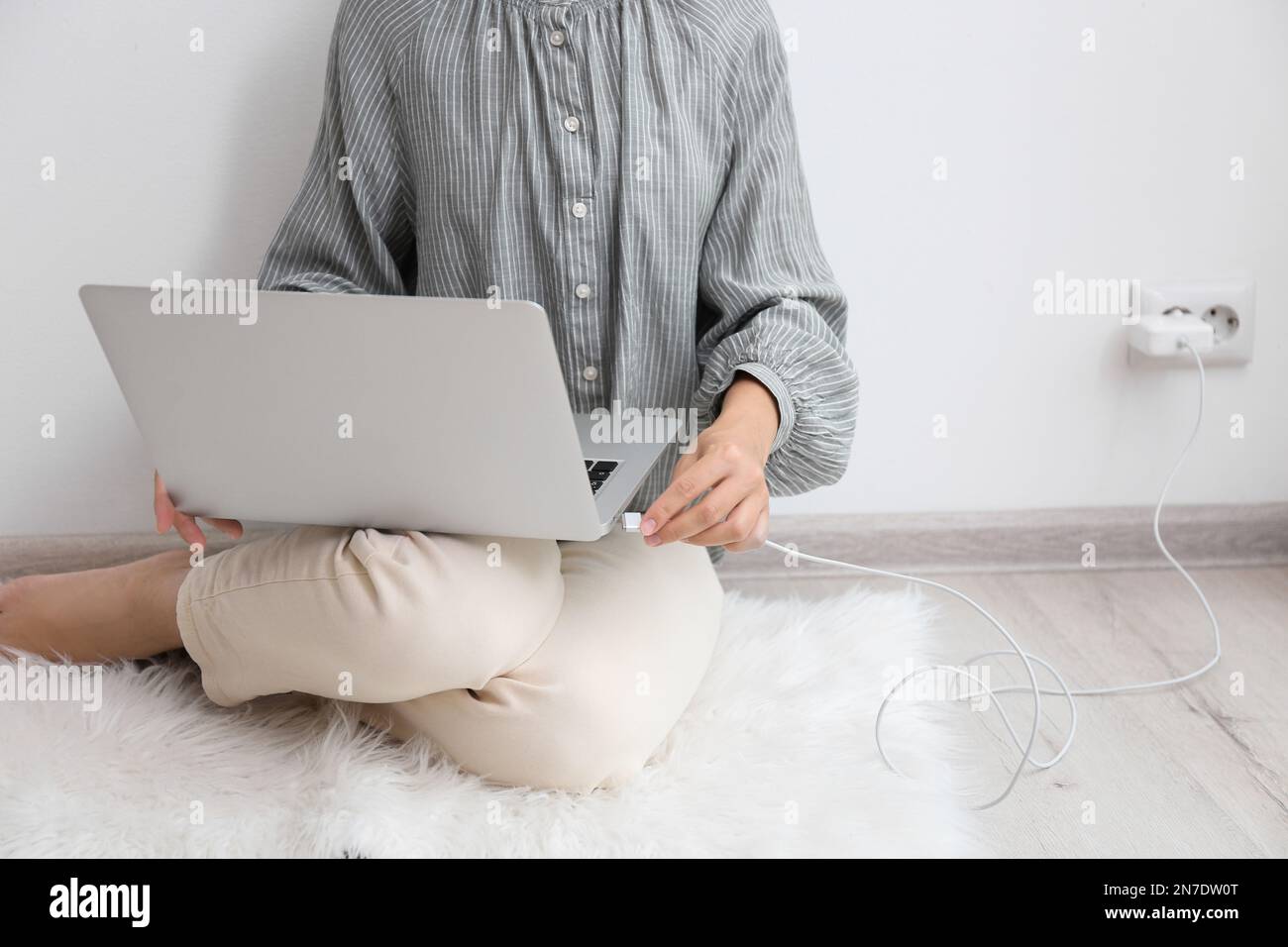 Woman connecting charger cable hi-res stock photography and images - Alamy