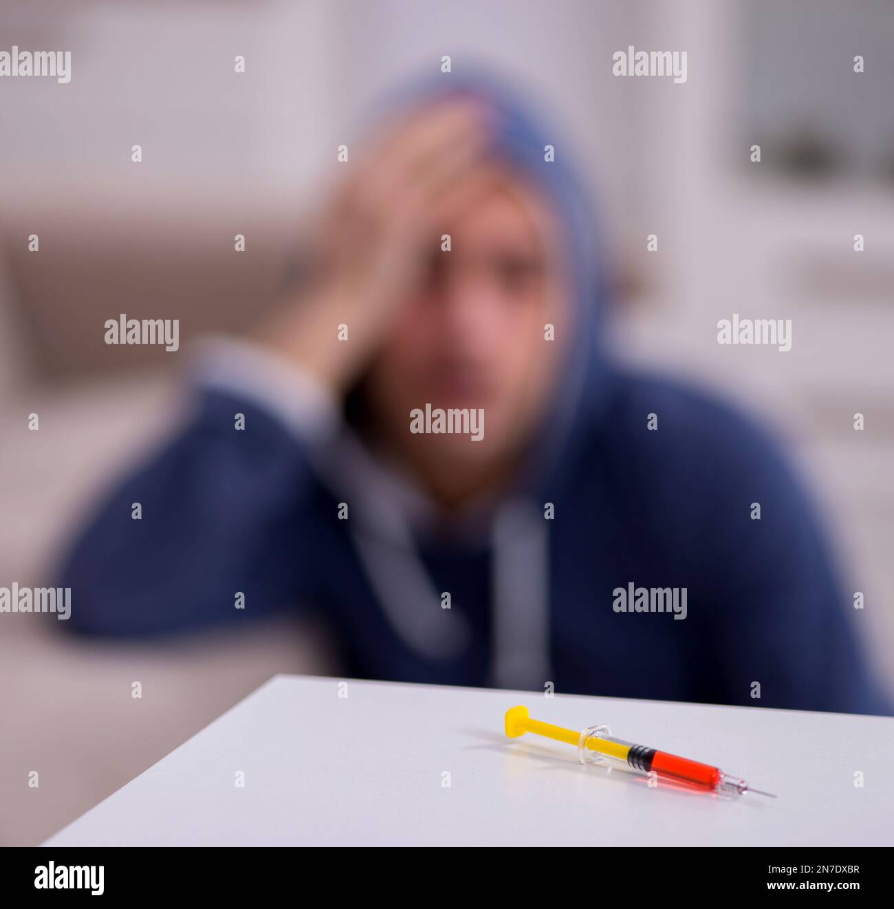 The young man having problems with narcotics at home Stock Photo - Alamy