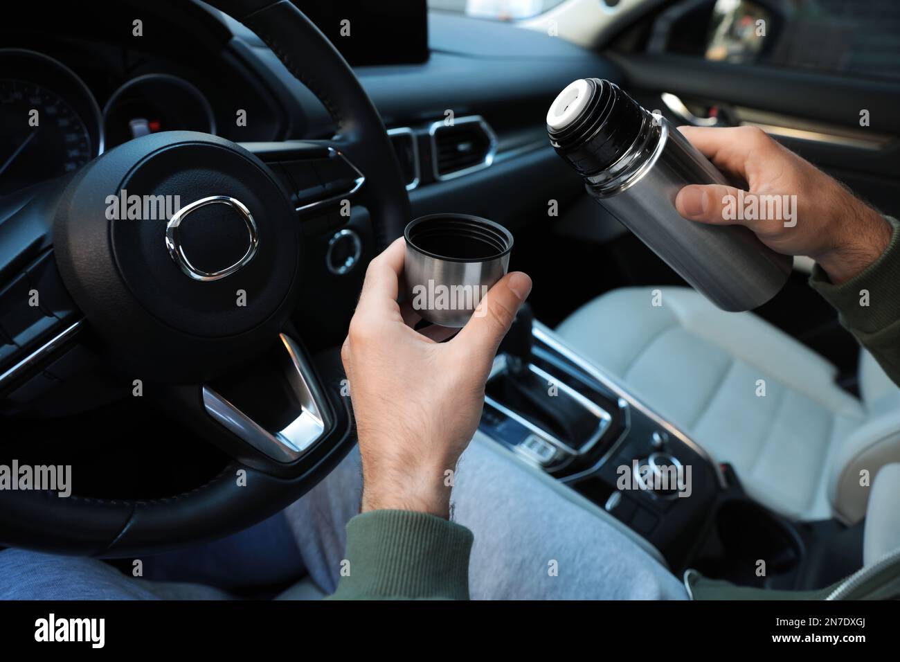 Man with thermos on driver's seat of car, closeup Stock Photo - Alamy