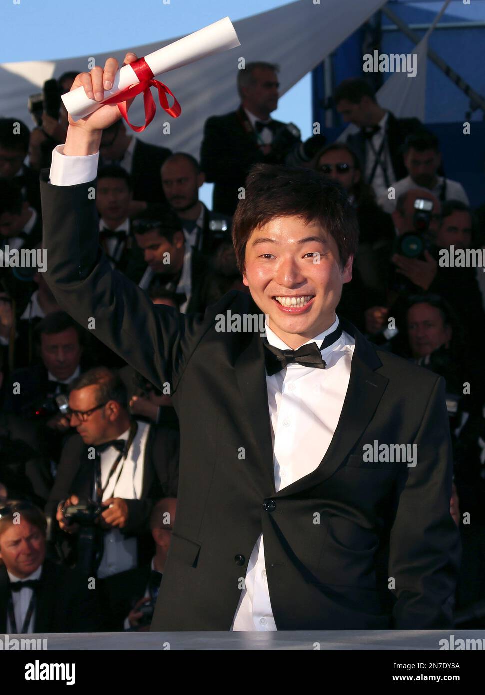 Moon Byoung-Gon holds up his Best Short Film award for his film Safe ...