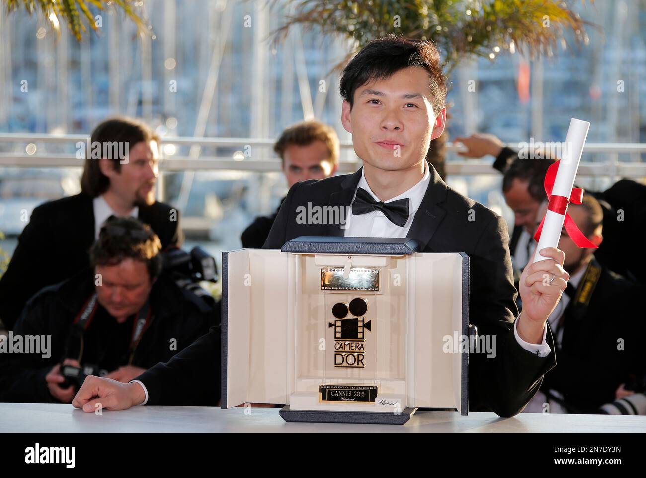 Director Anthony Chen poses with the Camera d'Or award for his film Ilo ...