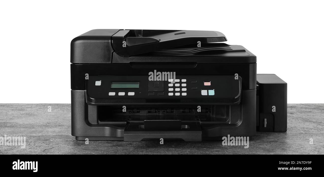 New modern multifunction printer on grey table Stock Photo - Alamy