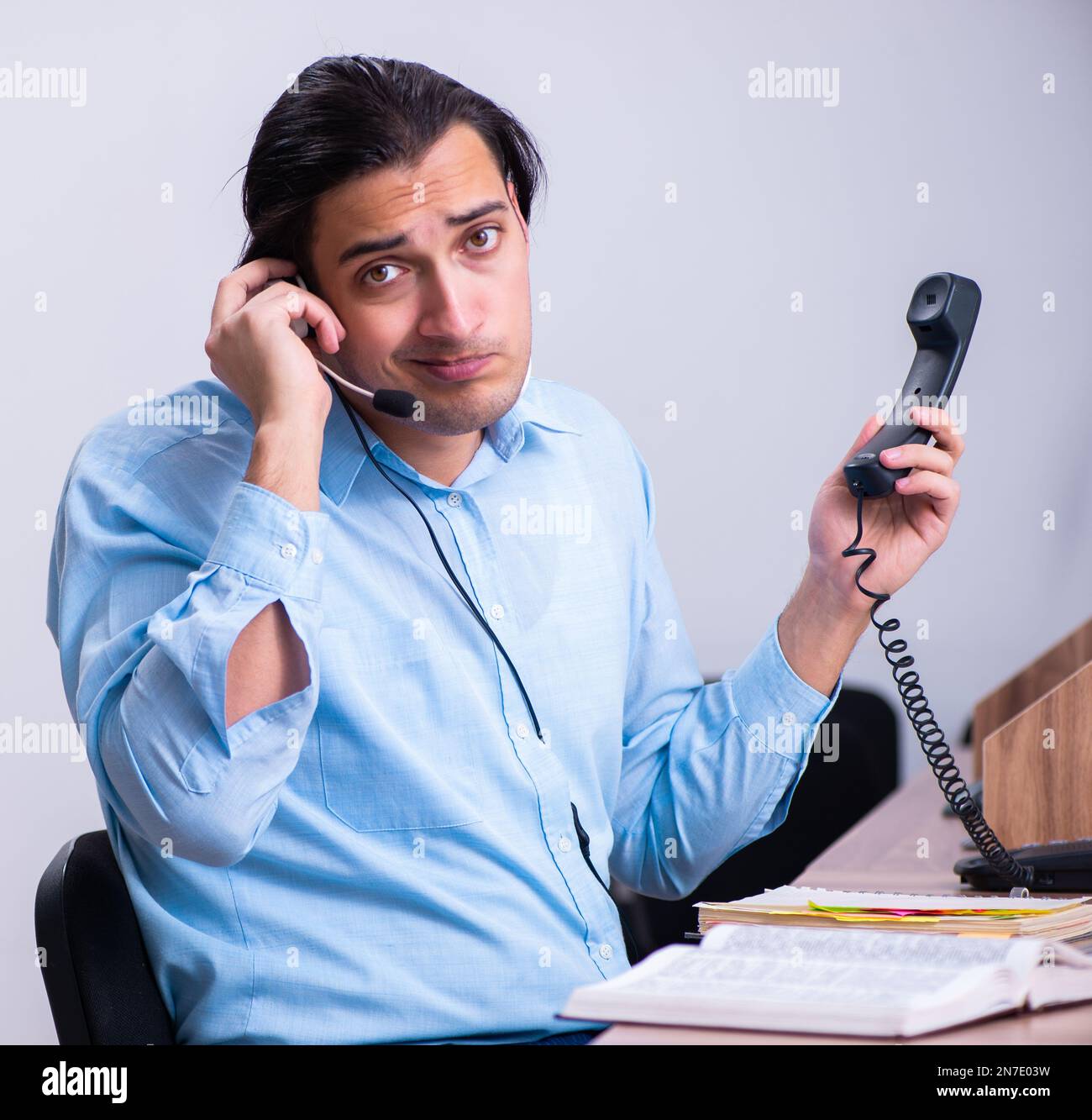 The call center operator working at his desk Stock Photo - Alamy