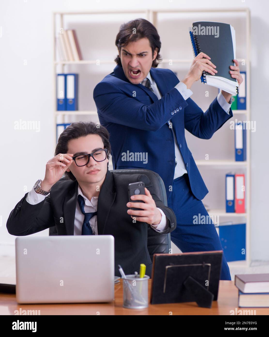 The boss and his male assistant working in the office Stock Photo - Alamy