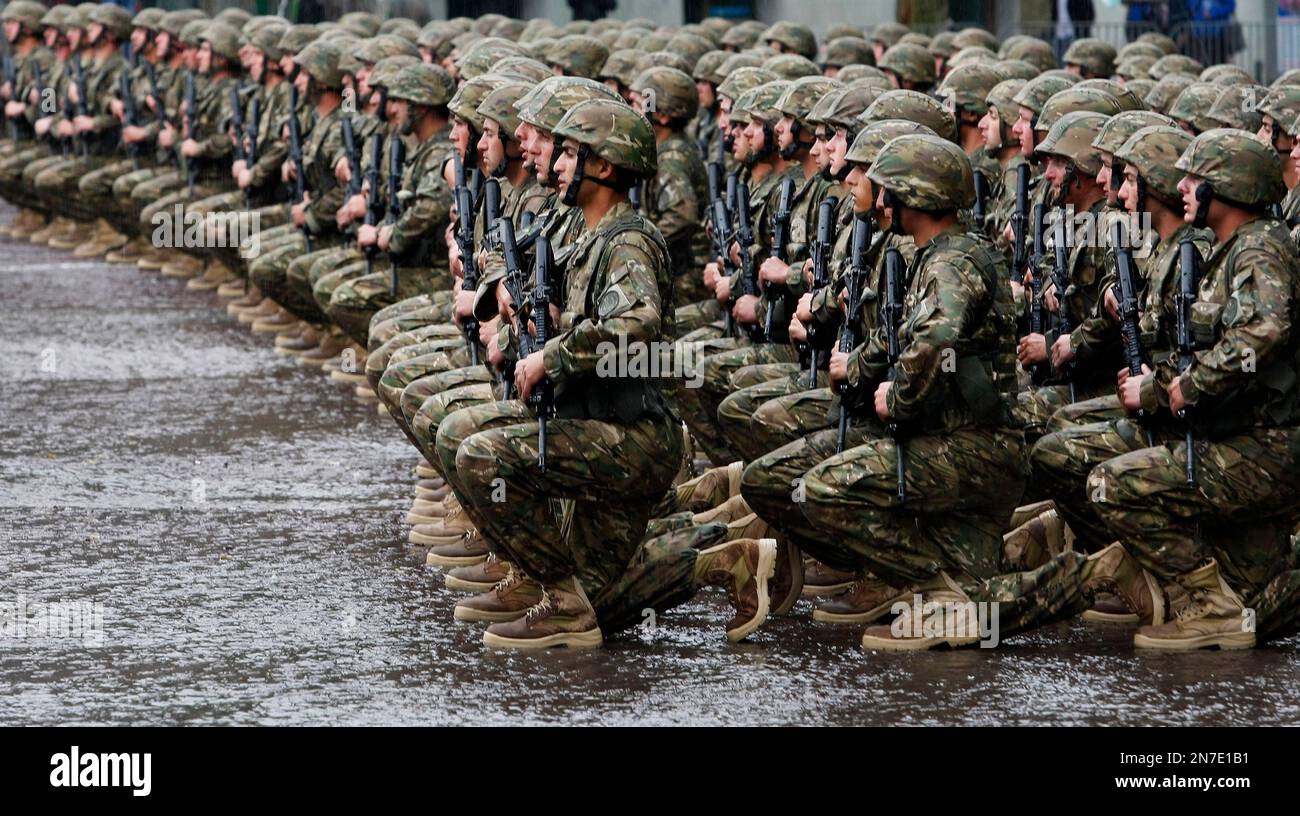 Georgian soldiers listen the national anthem as they mark an ...