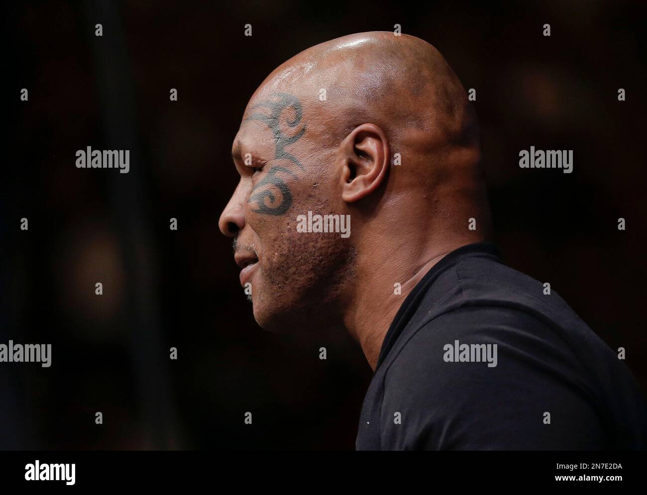 Mike Tyson makes his way up to the octagon to congratulate Glover ...