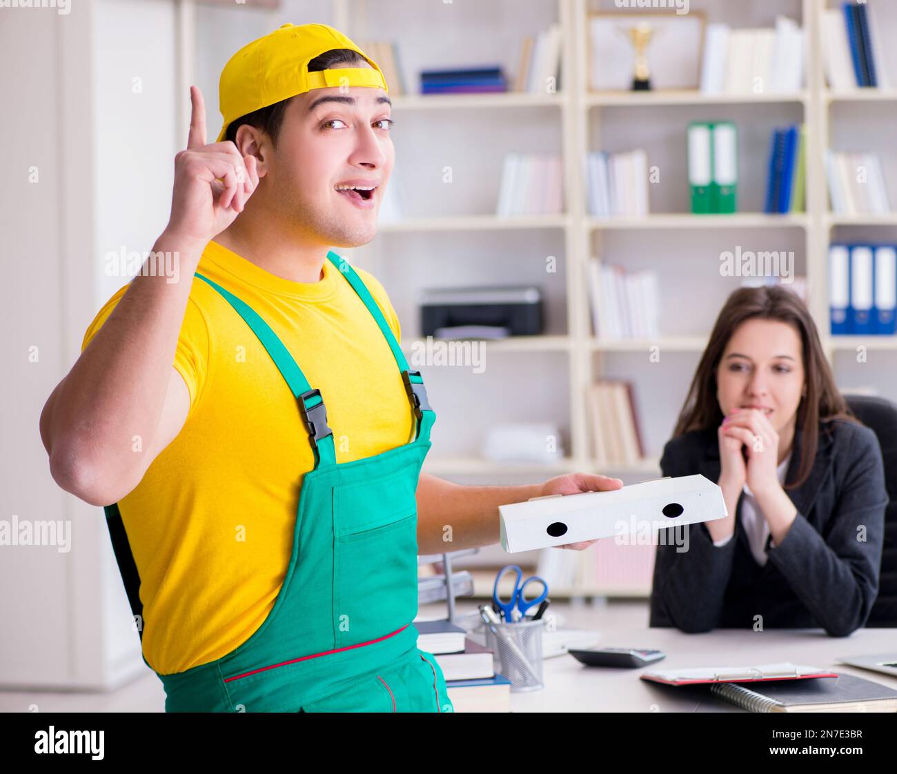 The postman delivering parcel to the office Stock Photo - Alamy